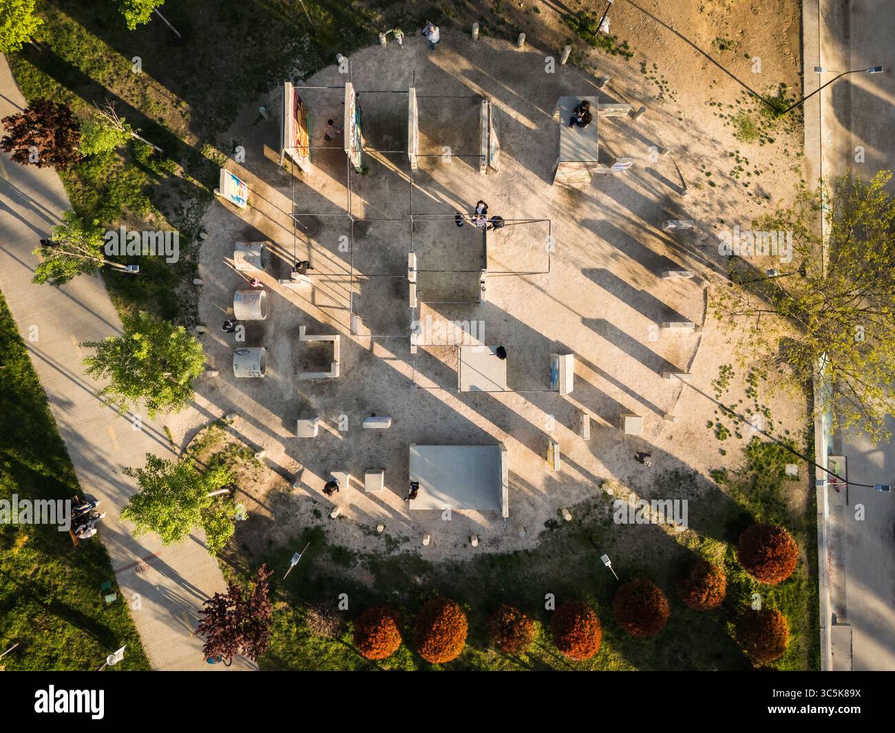 Aerial view of Mziuri Park's skate park with long shadows stretching ...