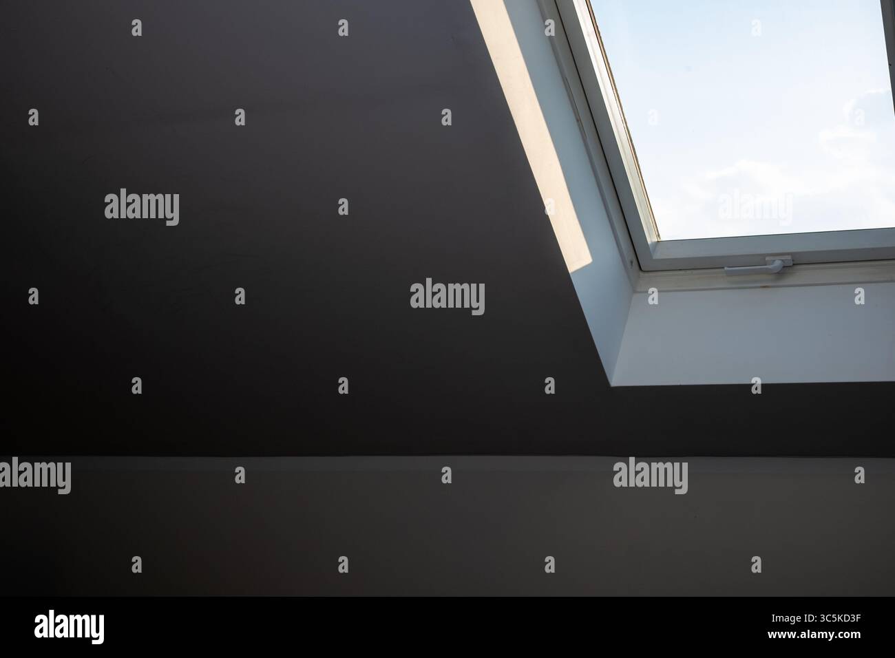 Modern skylight window illuminates room with natural light ...