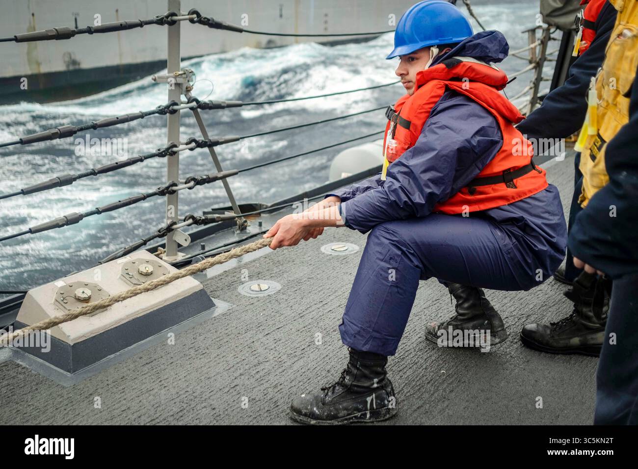 Seaman Matthew Chavana, from Victoria, Texas, heaves in a mooring line ...