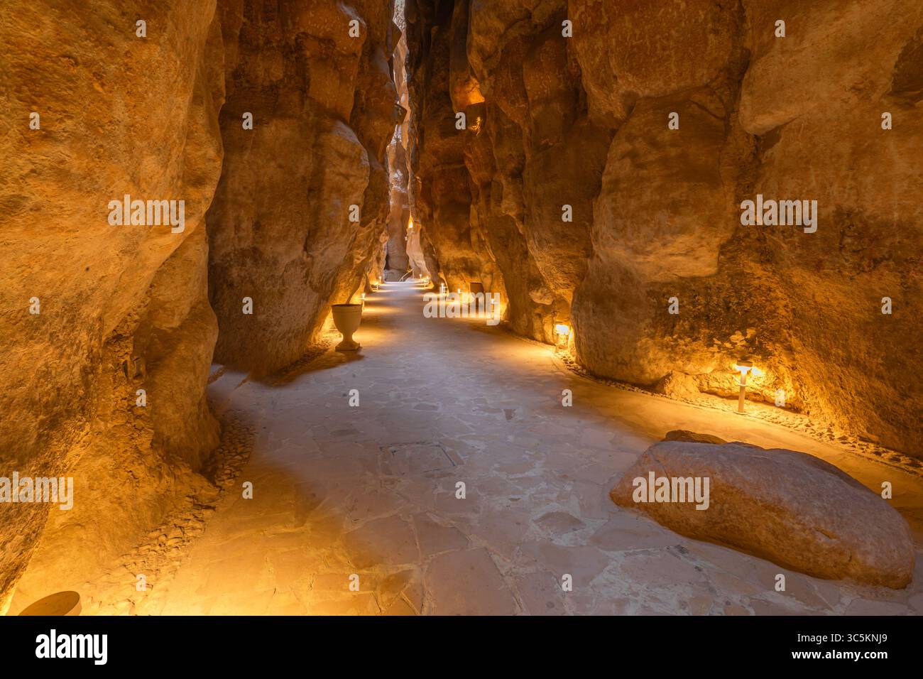 Warm lights illuminating a pathway in the sandstone cave system at ...