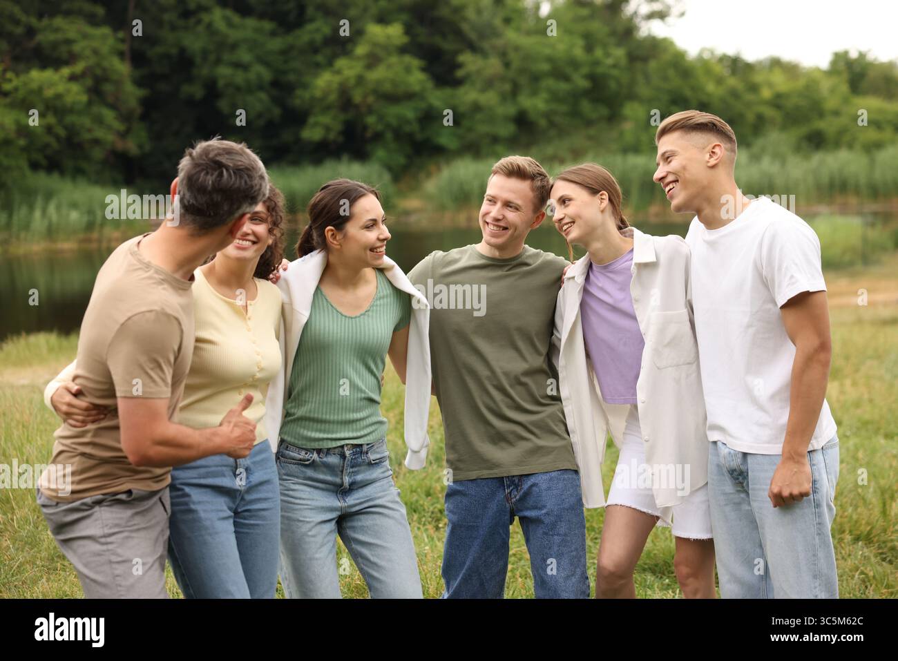Team building. Group of happy people together outdoors Stock Photo - Alamy