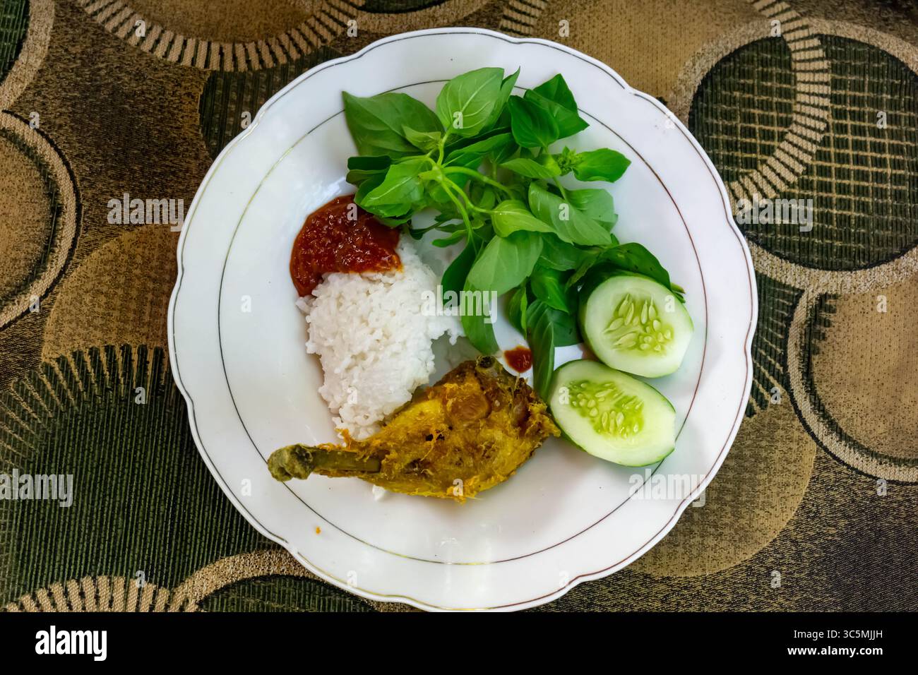 A plate contains steamed white rice, fried chicken hi-res stock ...