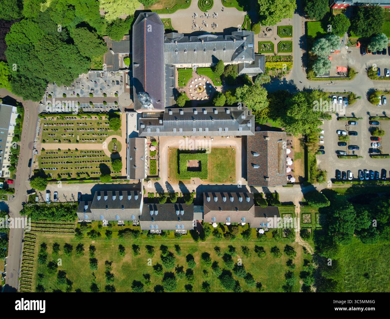 Aerial view of a historic building complex with manicured gardens and a ...
