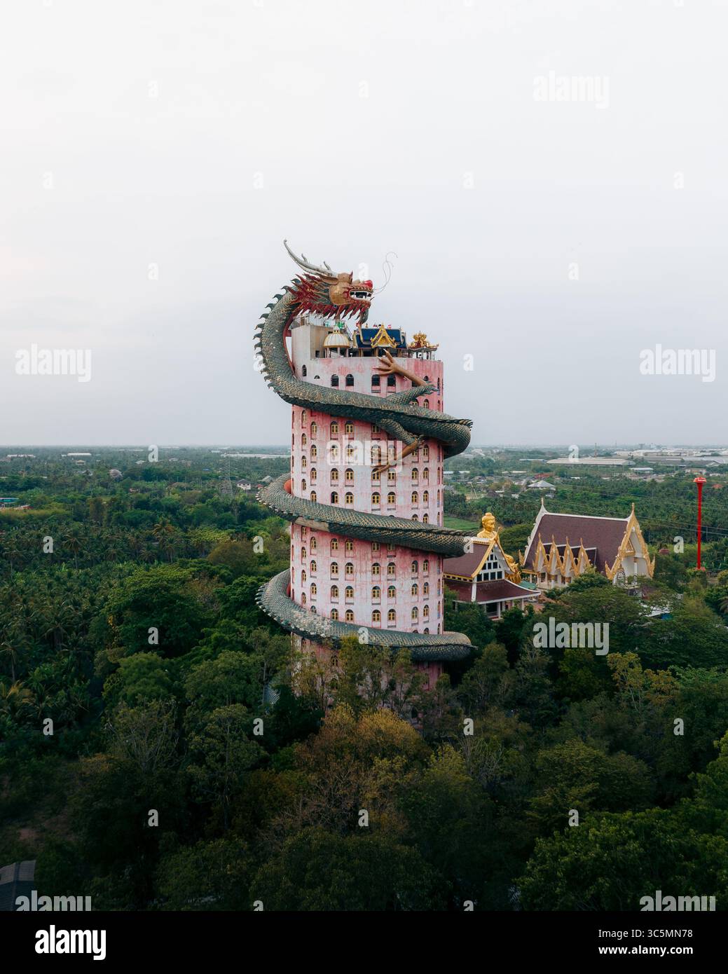 Aerial view of the striking pink temple embraced by a sculpted dragon ...
