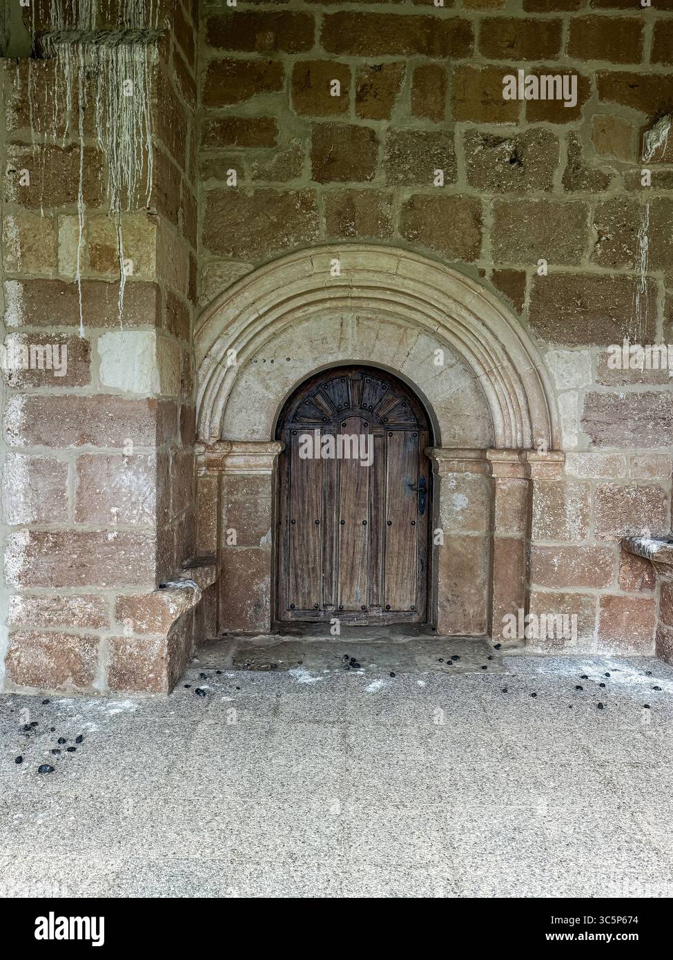 Historic church doorway featuring a rounded stone arch and old wooden ...