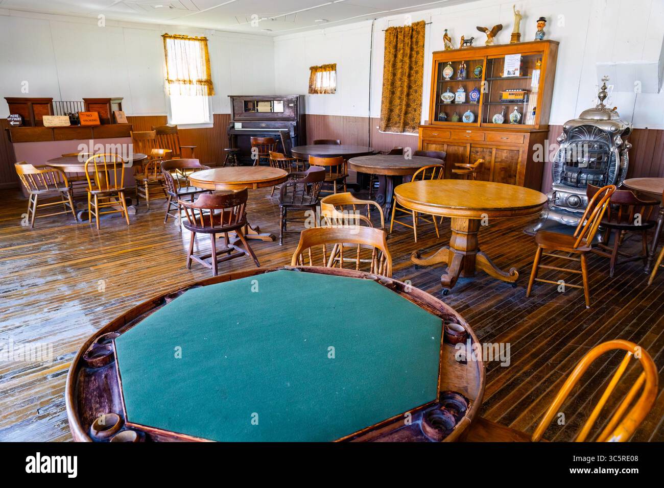Inside a vintage saloon room with card games tables Stock Photo - Alamy