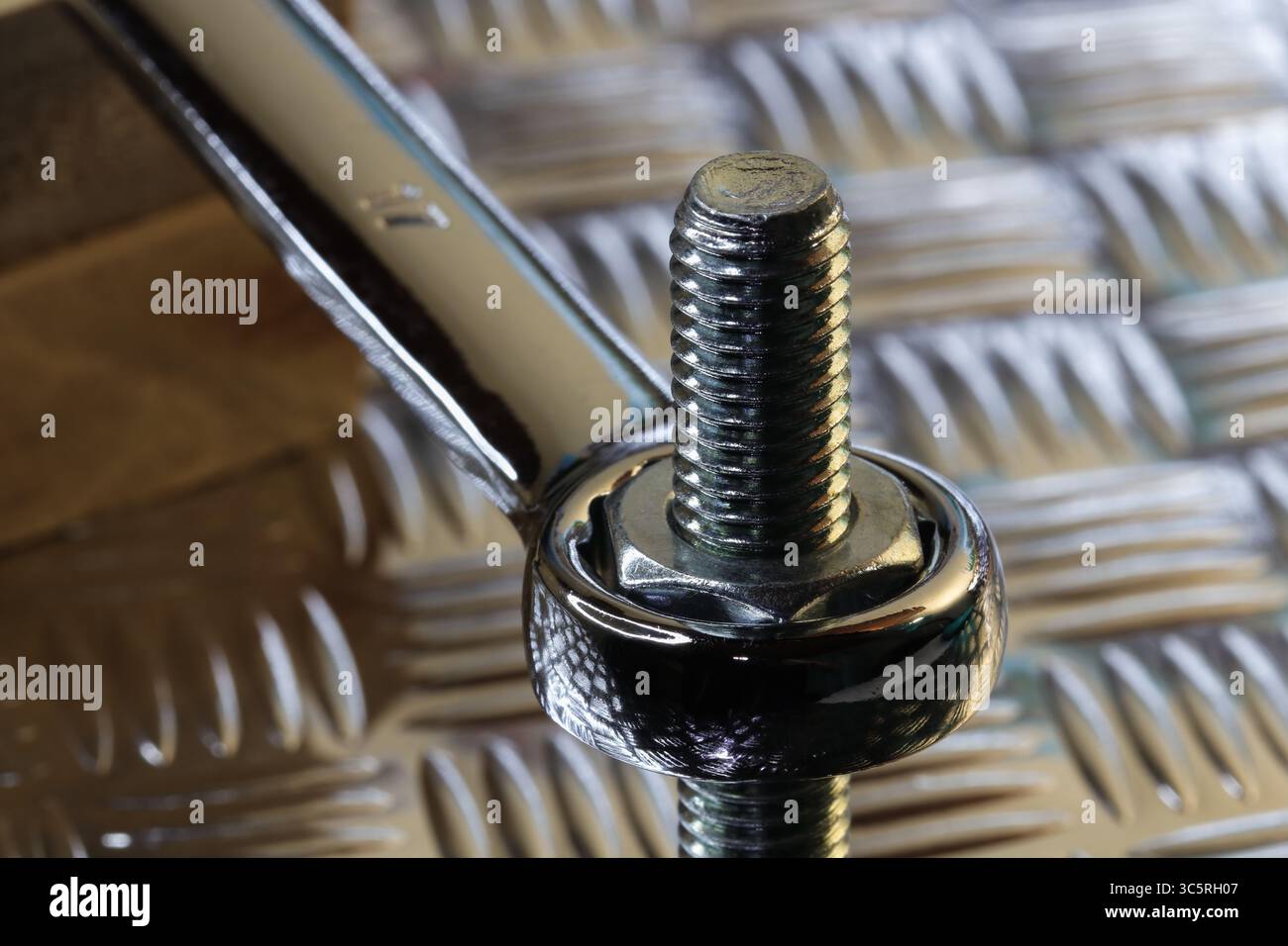 Tightening Nut On Bolt With Chrome Spanner Stock Photo - Alamy