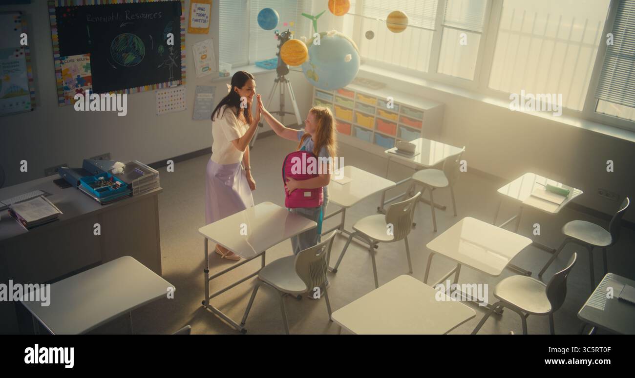 End of the School Day: Elementary School Girl Packing Her Backpack ...