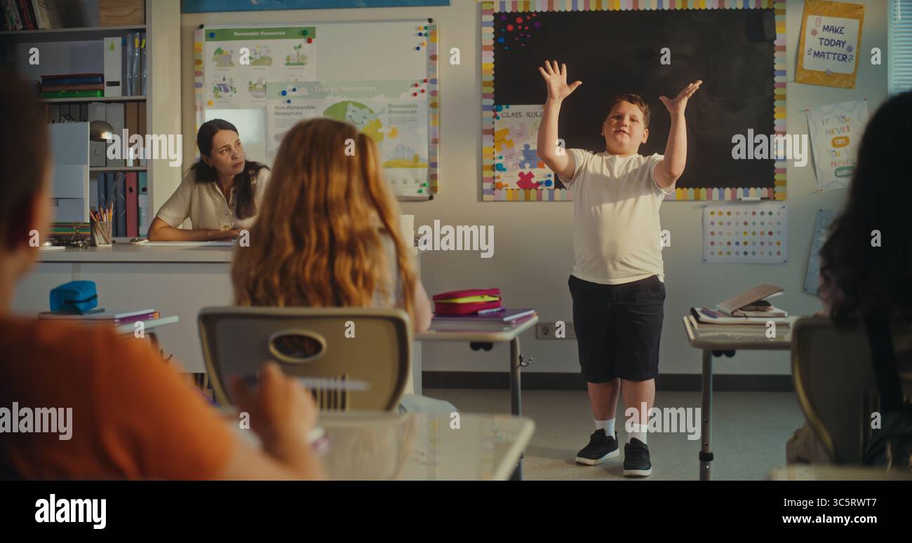 Primary School Boy Showcasing Knowledge of Ecology in Front of Class ...