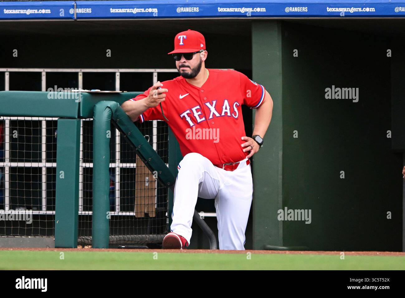 ACL Rangers bench coach Kevin Torres stands in the dugout during an ...