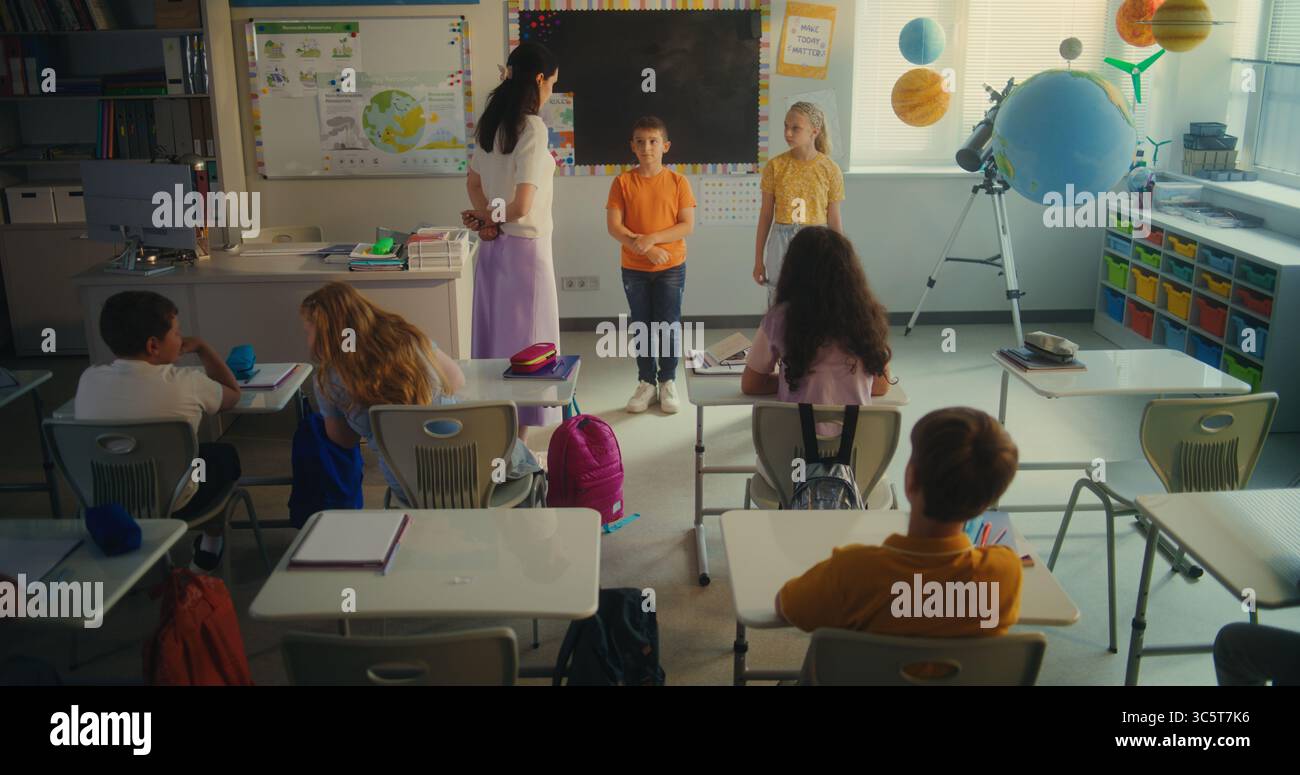 Science Lesson: Primary School Boy and Girl Presenting Homework on ...