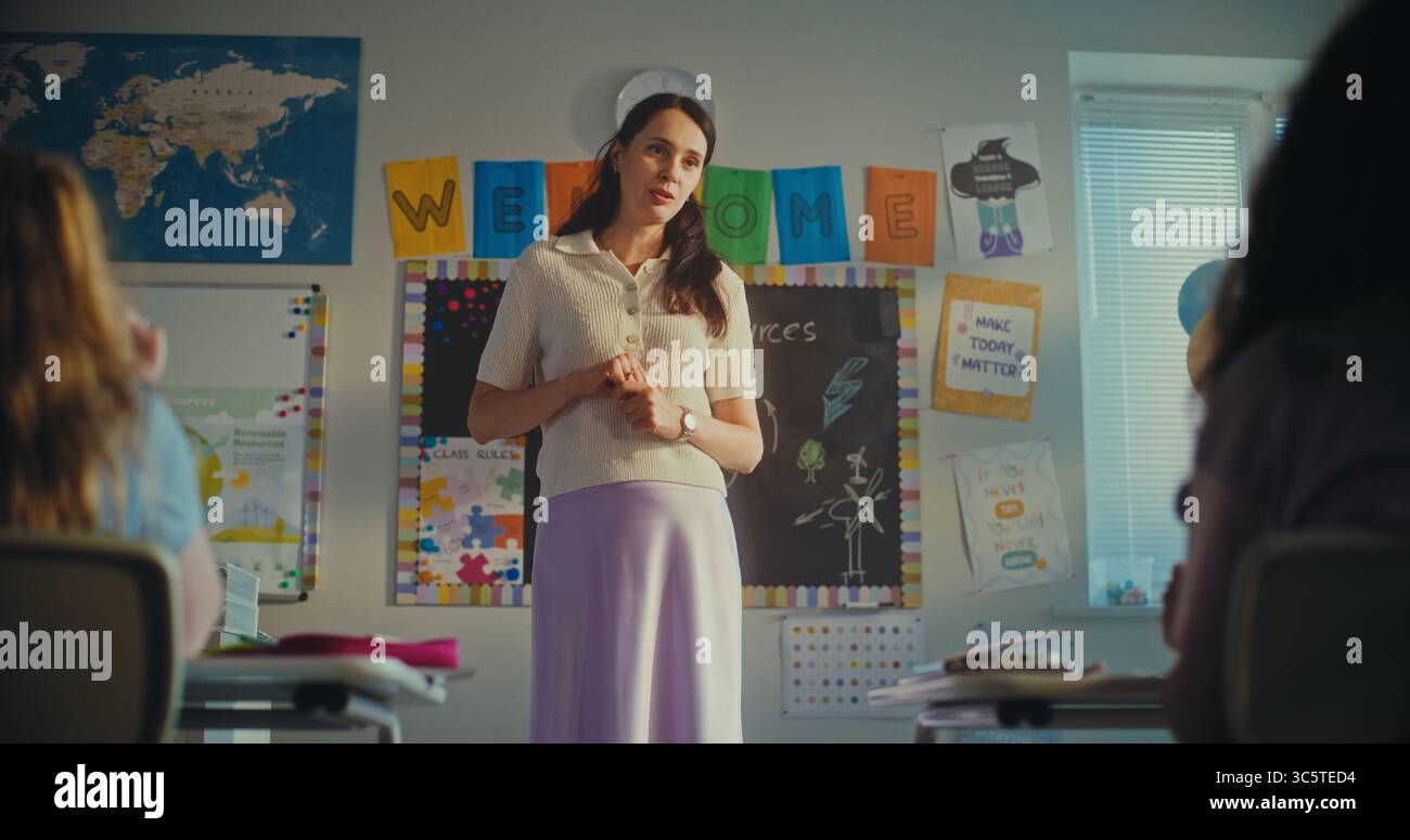 Female Teacher Starting Lesson, Teaching Ecology to Primary School Children in Classroom. Group ...