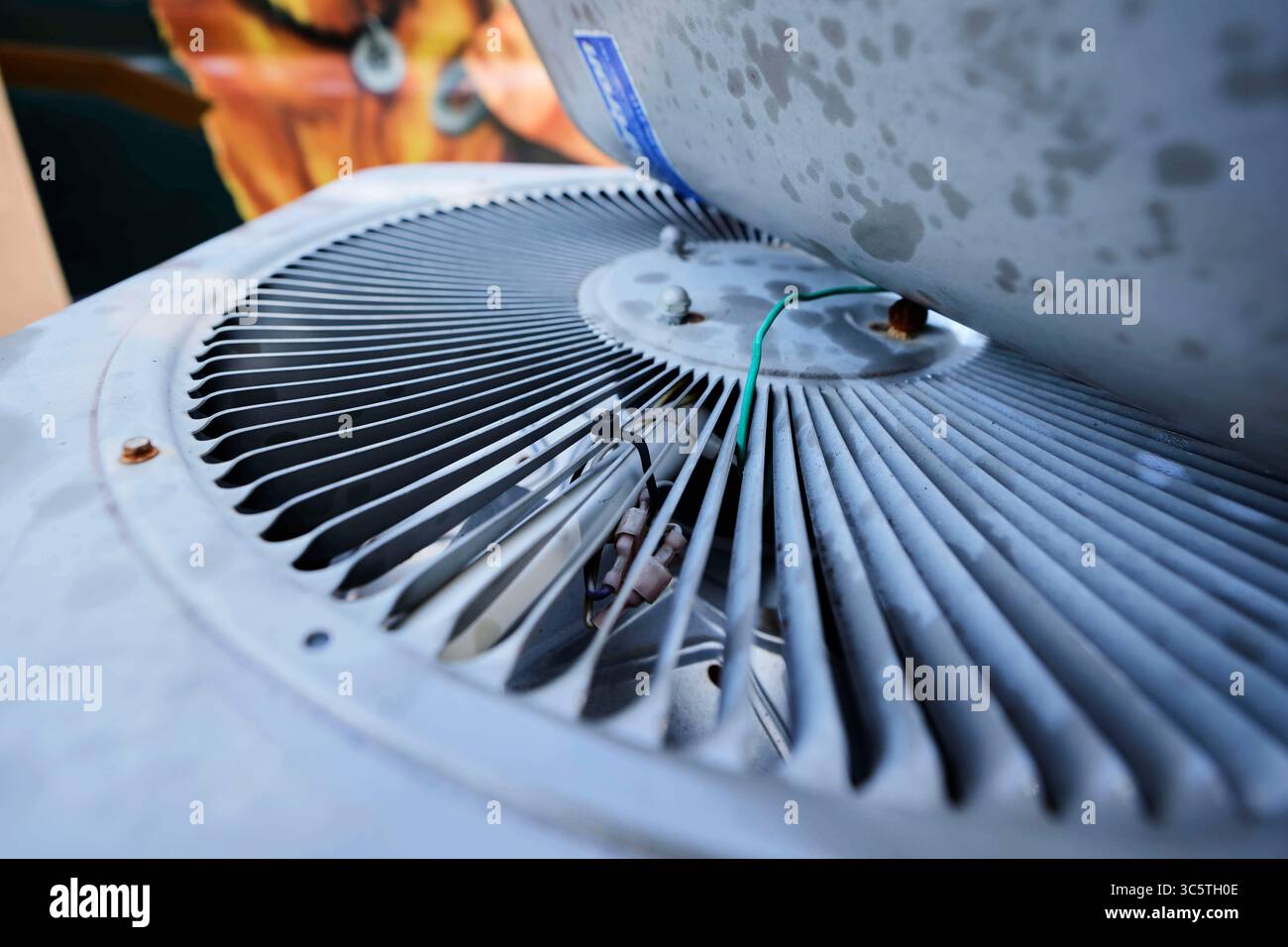The old air conditioning condenser removed from a residential home sits ...