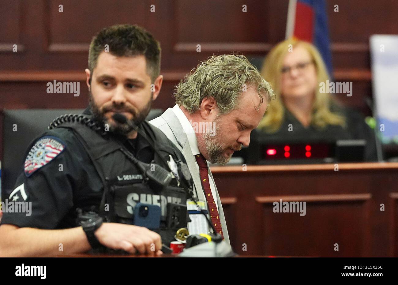 Dentist James Craig, front, is led past Judge Shay Whitaker after the ...