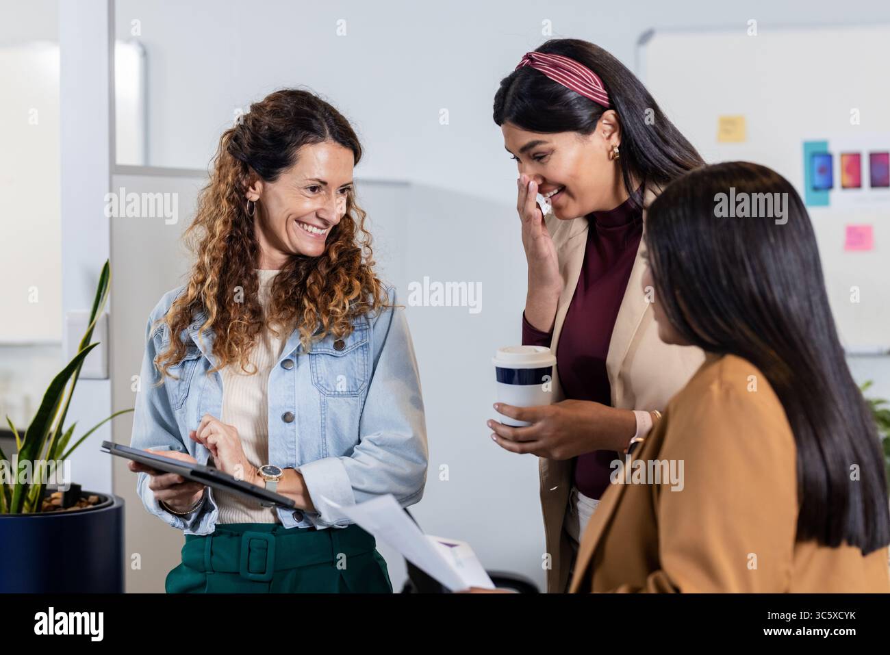 Smiling female professional reviewing notes hi-res stock photography ...