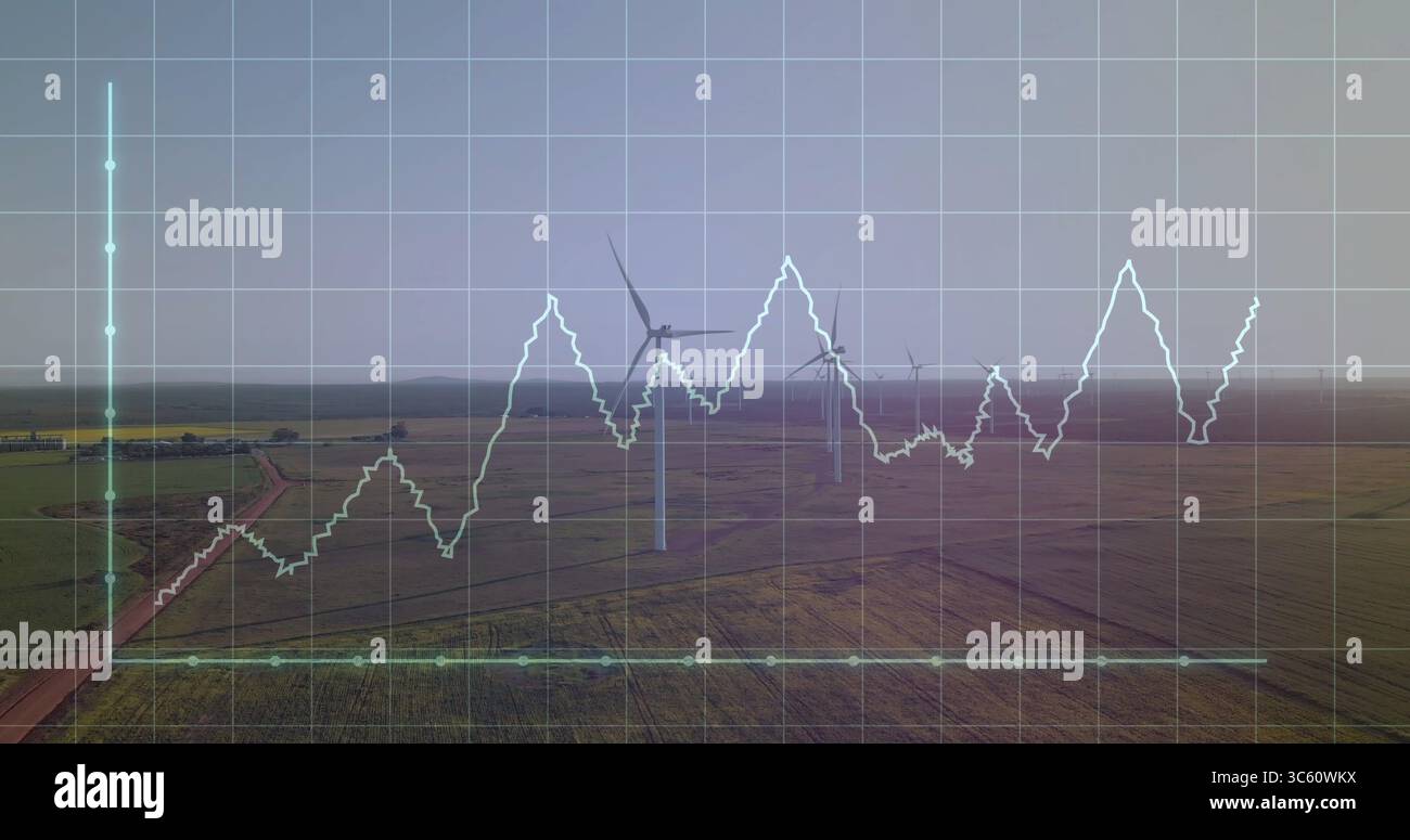 Rotating wind turbines rising above crop fields across dirt roads, with ...