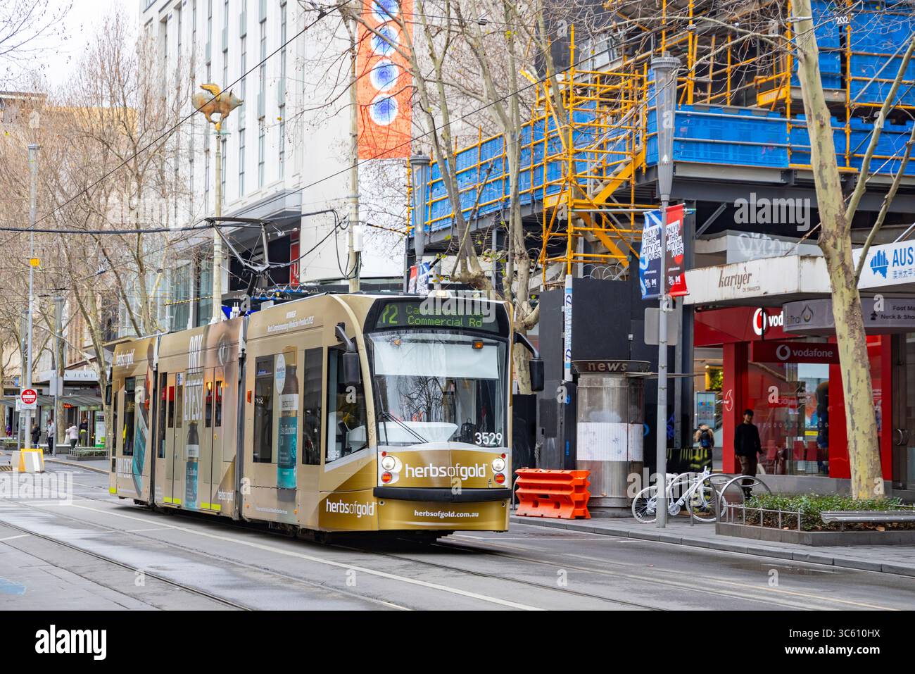 Yarra trams gold coloured Melbourne tram travelling along Swanston ...