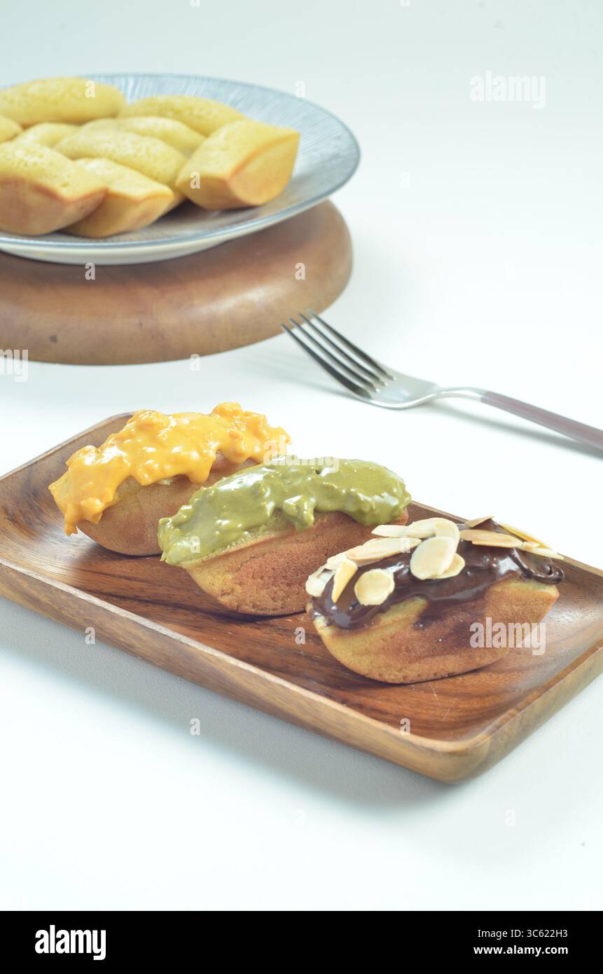 Pukis cake with various toppings of chocolate, cheese, peanuts, and ...