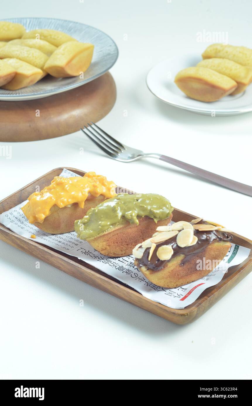 Pukis cake with various toppings of chocolate, cheese, peanuts, and ...