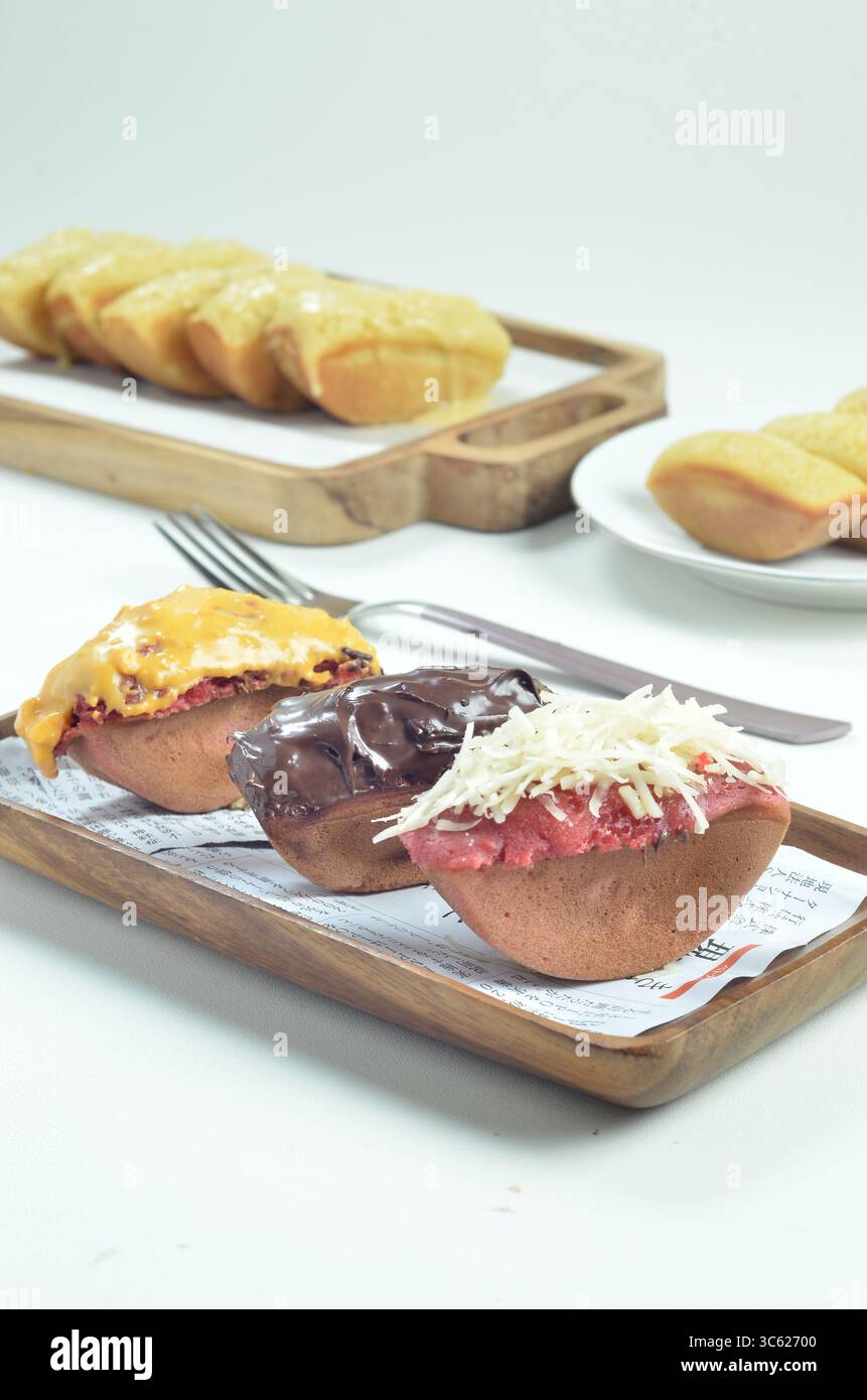 Pukis cake with various toppings of chocolate, cheese, peanuts, and ...