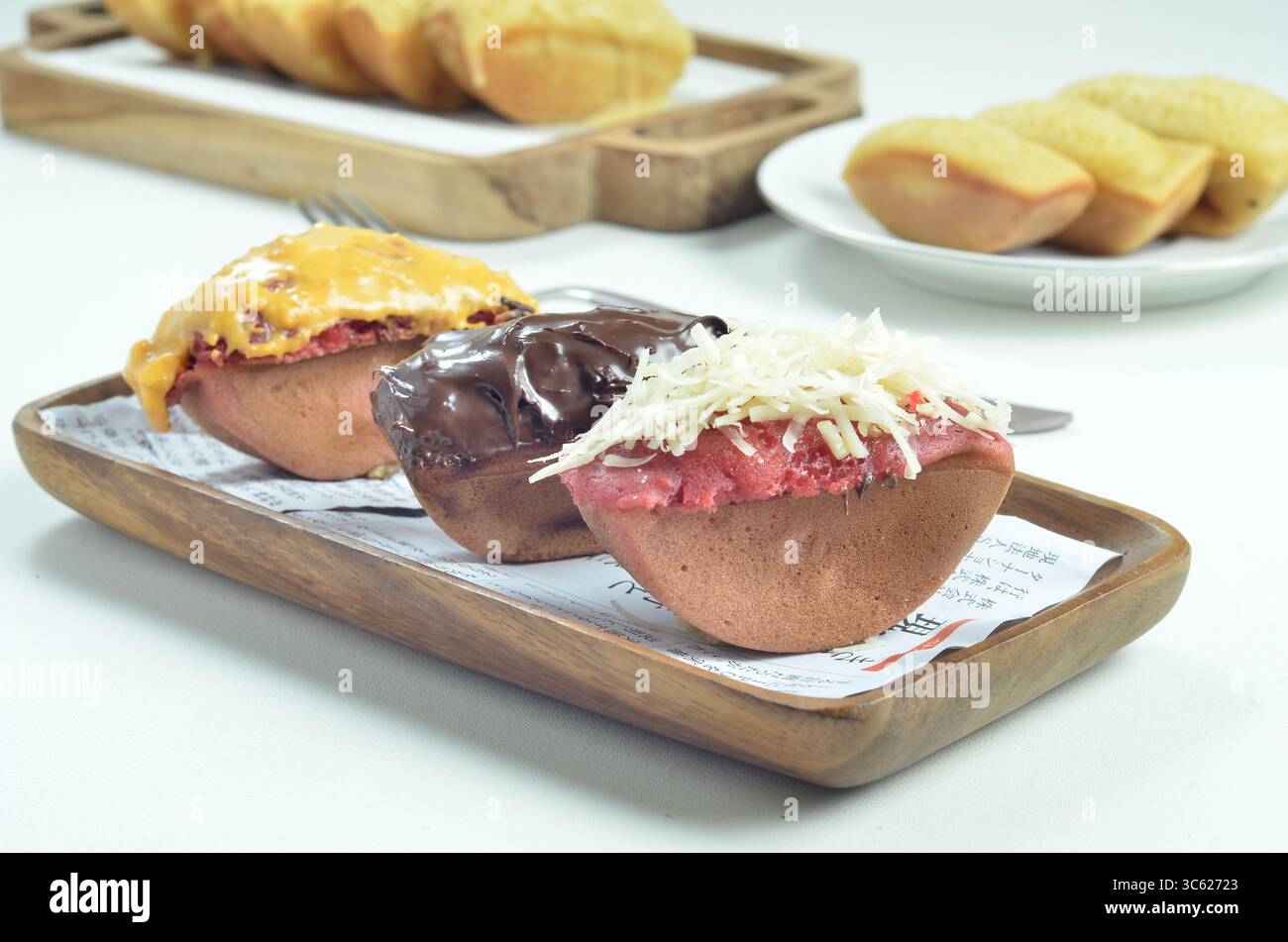 Pukis cake with various toppings of chocolate, cheese, peanuts, and ...