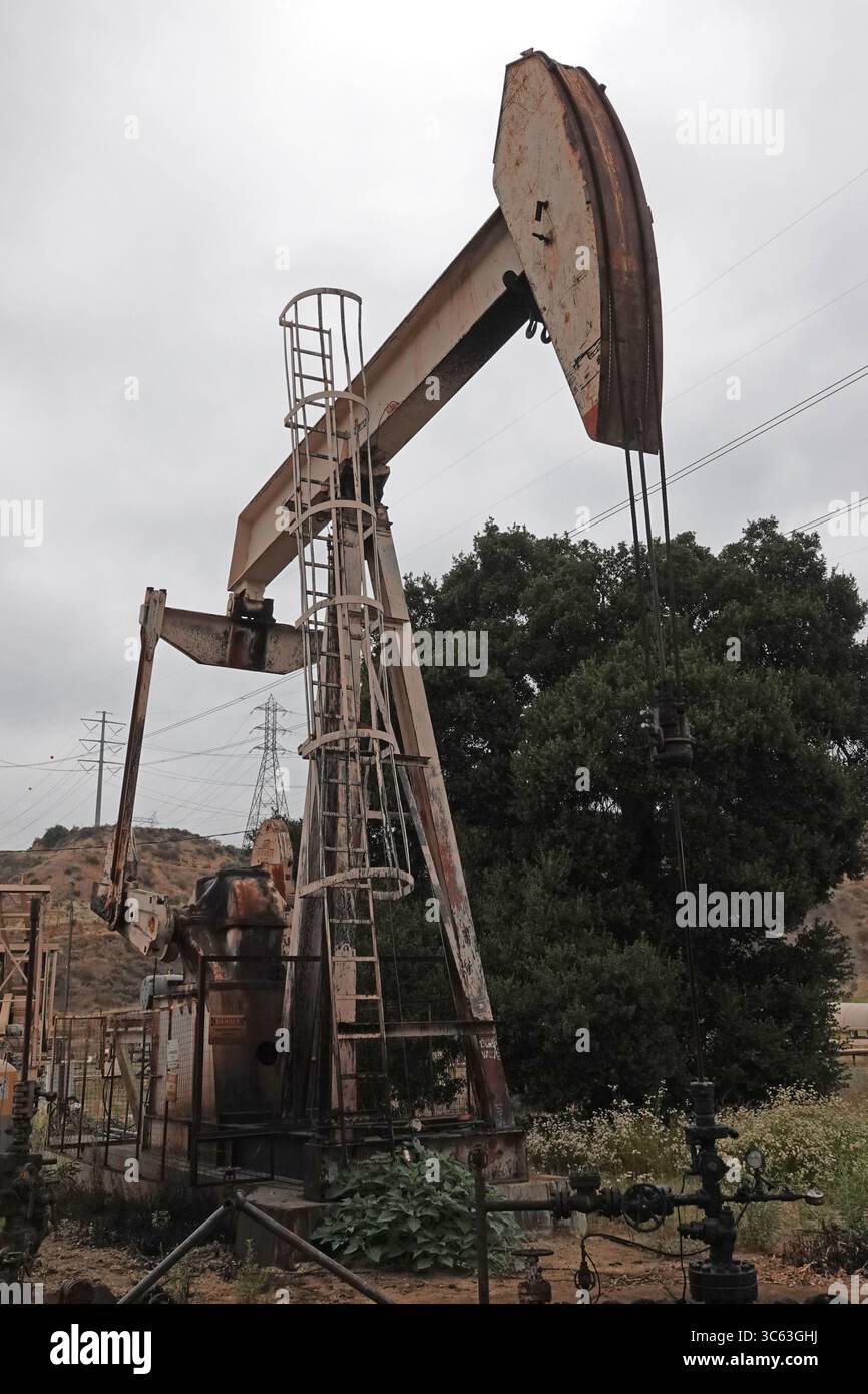 A pumpjack AKA nodding donkey is shown up close as it pumps oil from a ...