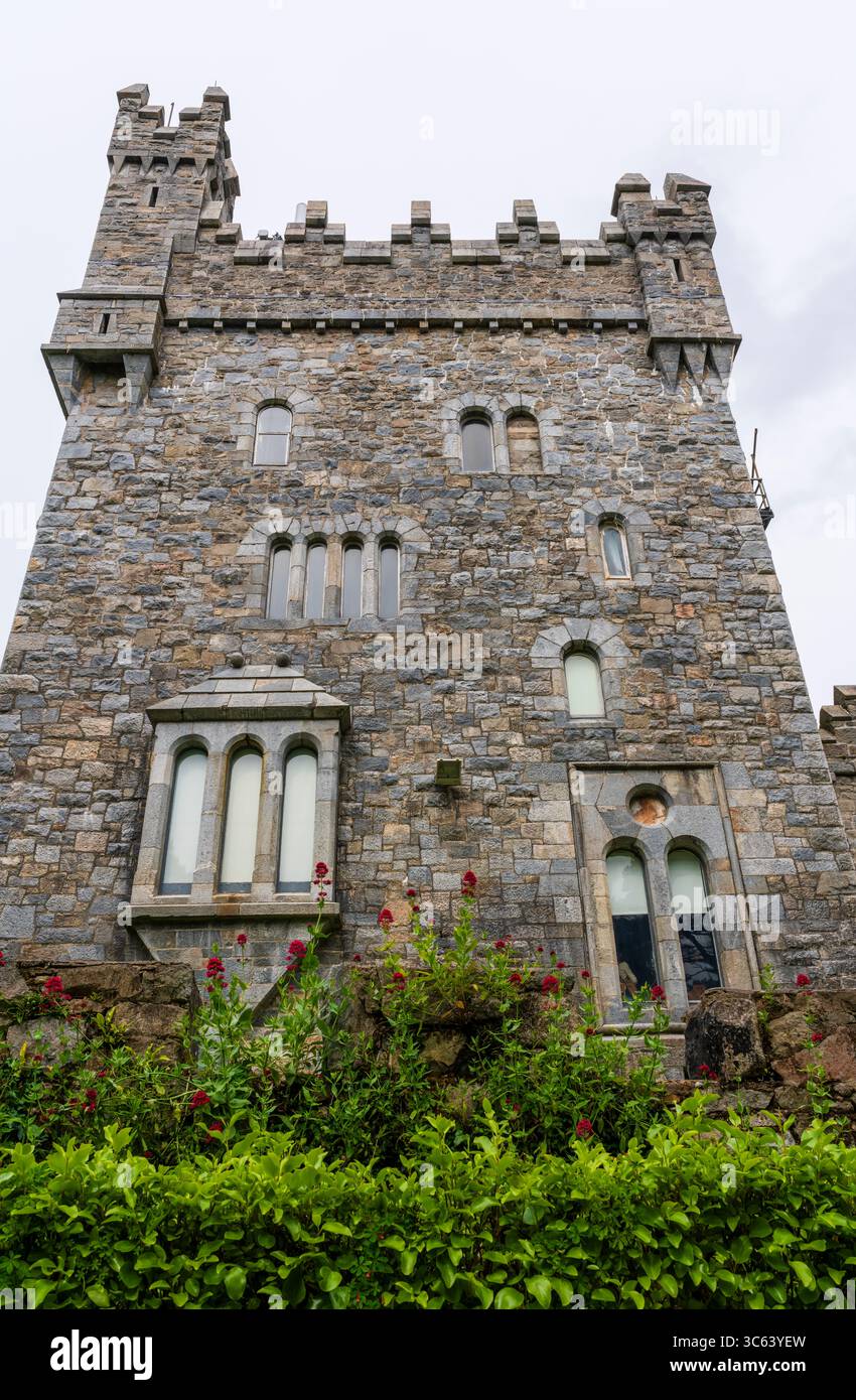Stone tower of Glenveagh Castle with arched and narrow windows ...