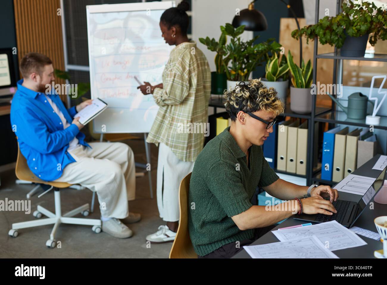 Collaborating professional group typing hi-res stock photography and ...
