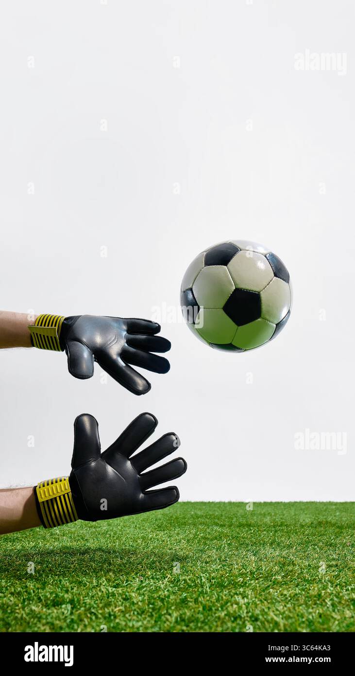 Football goalkeeper hands in gloves reaching for flying ball Stock ...
