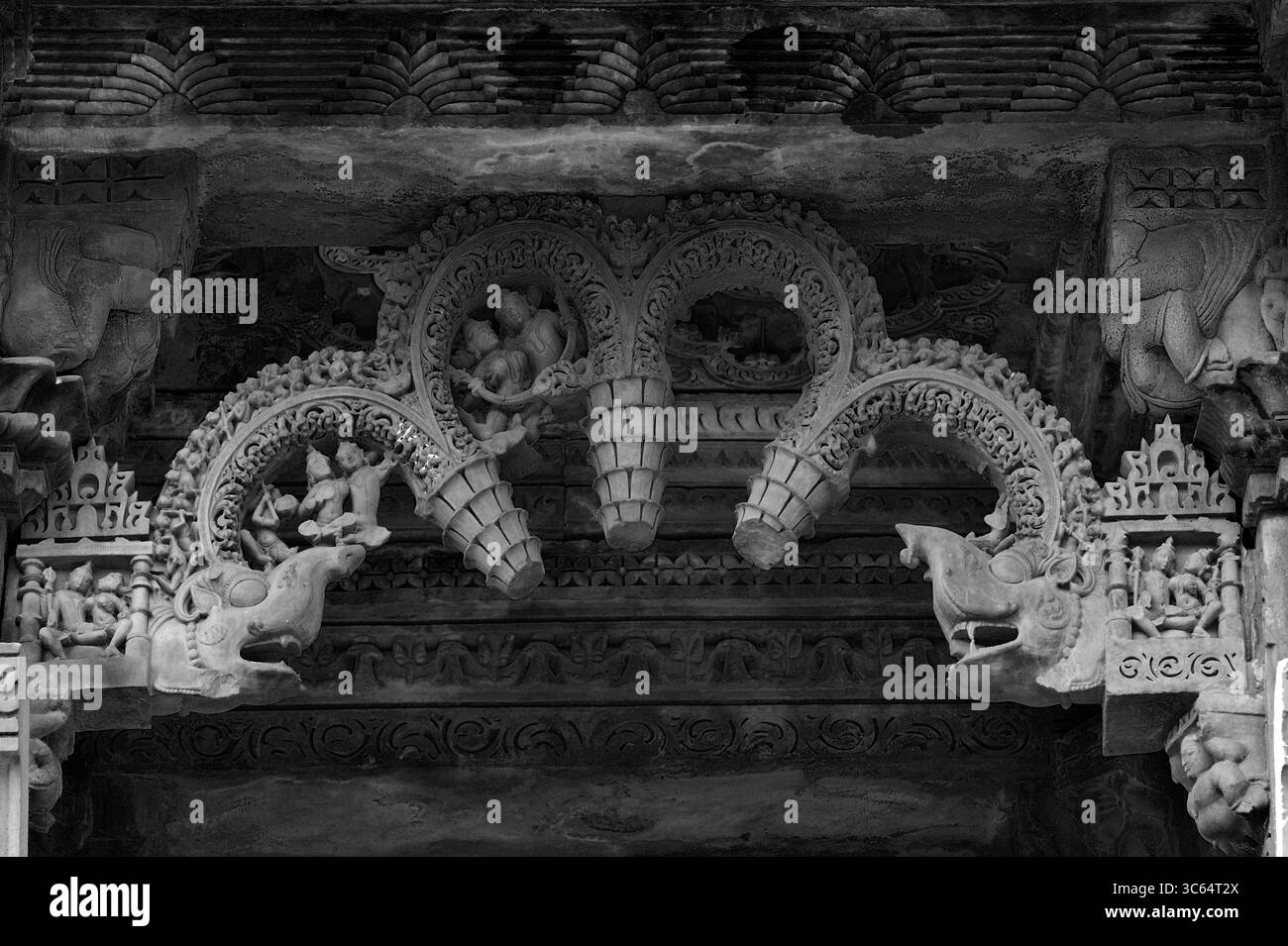 Black and white photo of details of makara Torana of Kandariya Mahadeva Temple of Khajuraho ...