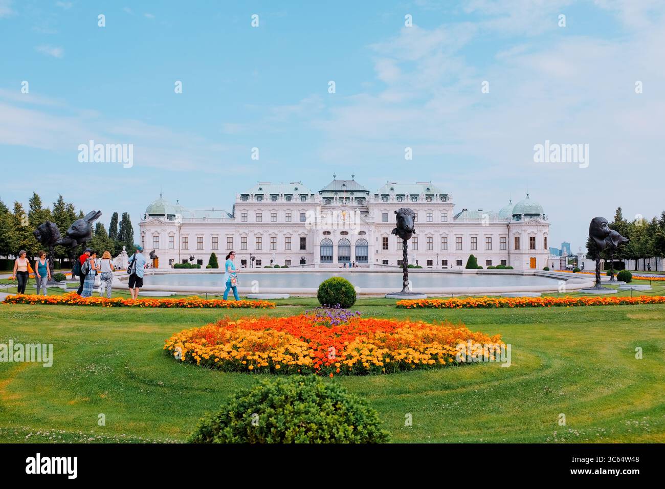 Visitors stroll in the formal garden of Belvedere Palace, a Baroque ...