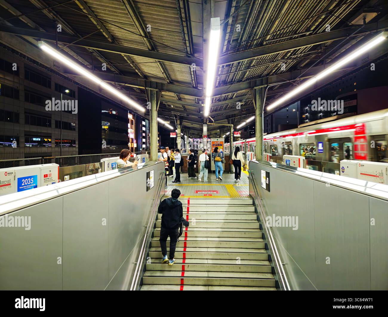 Night Commuters on Esaka Station Platform, Osaka, Japan Stock Photo - Alamy