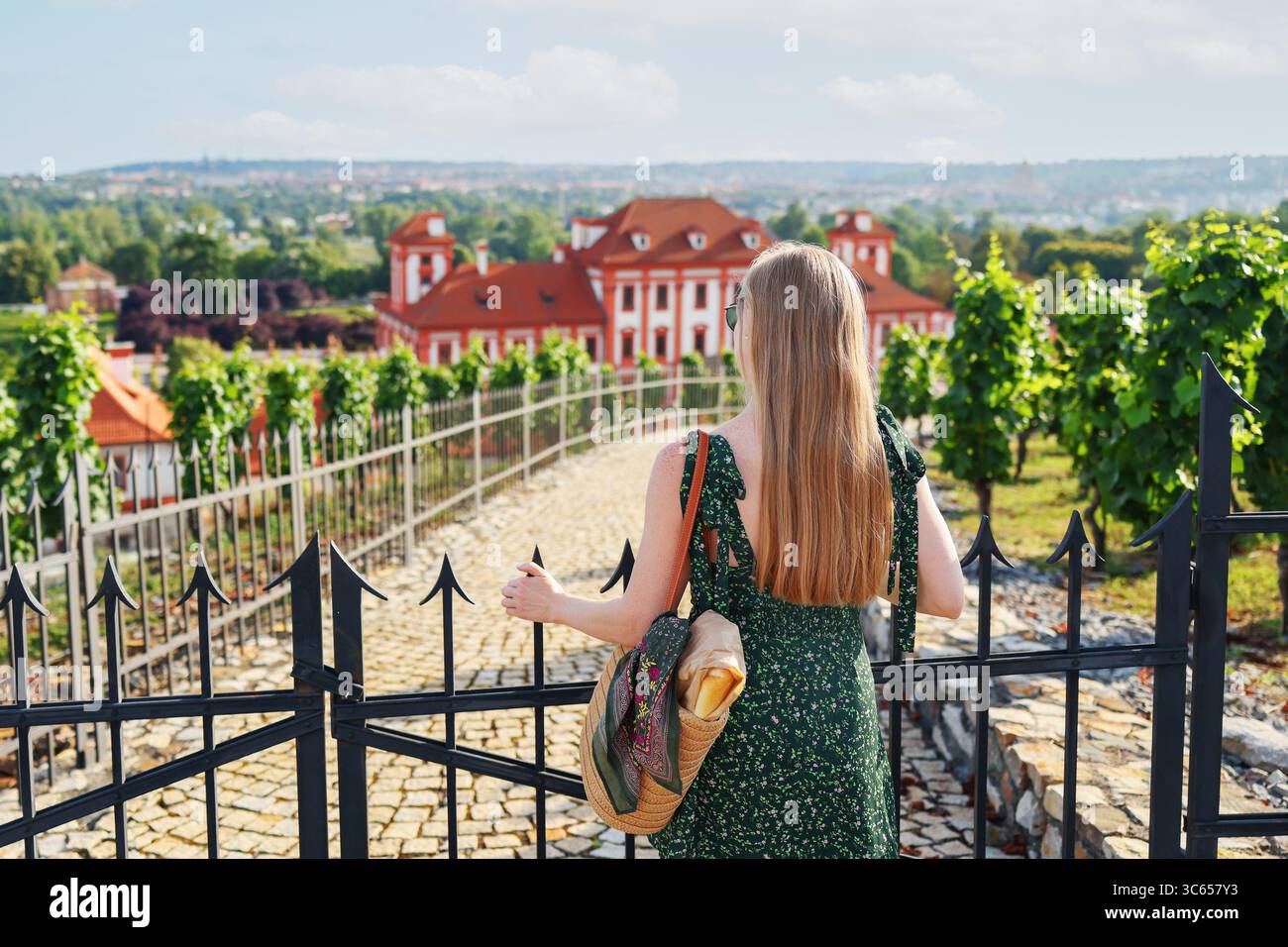 Tourist exploring vineyard terrace with panoramic view and historic ...