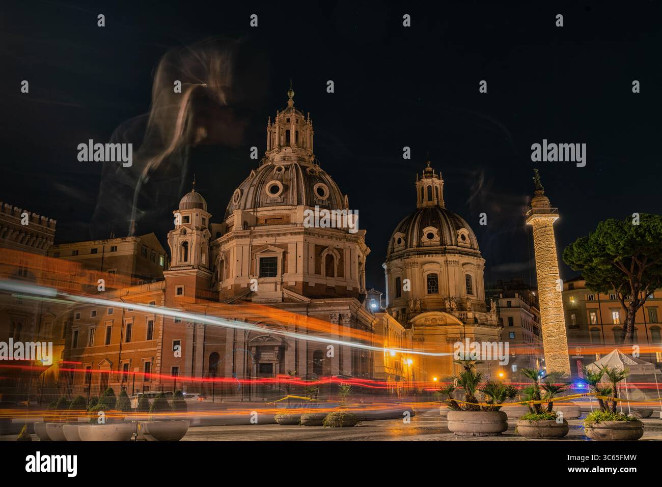 View of illuminated Trajan's Column and the domed churches against the ...