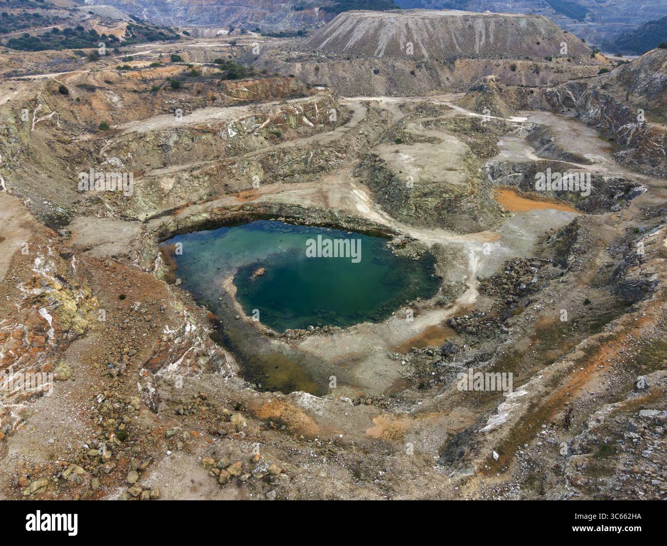 Aerial view of a stark, terraced landscape cut deep to reveal a ...