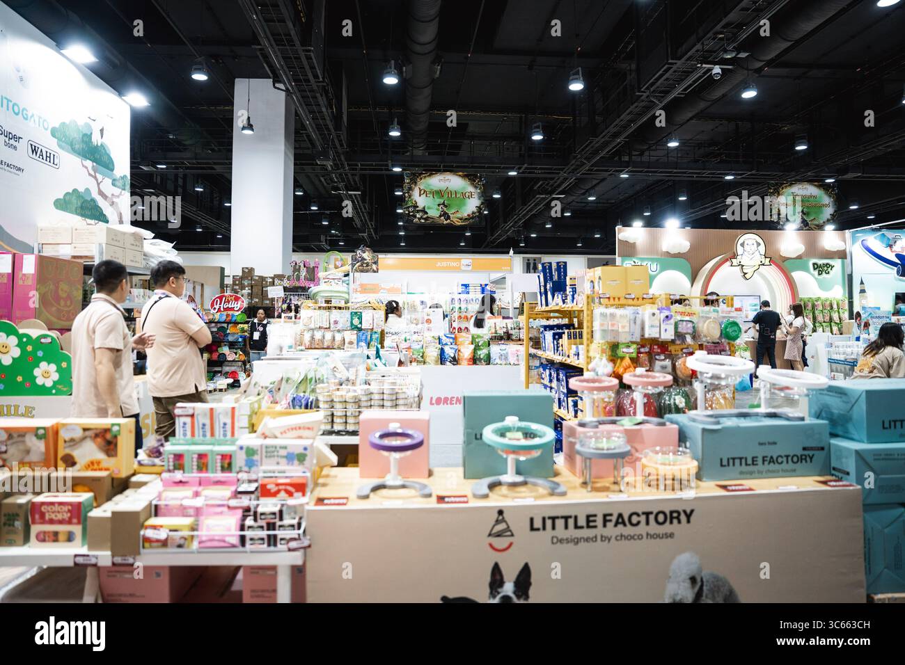 Pet product booths and colorful displays fill the exhibition hall ...