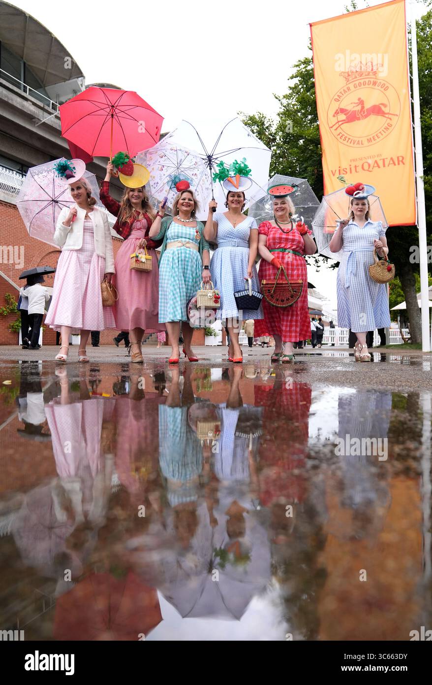Milliner Anna Gilder (third right) and friends pose for photographs ...