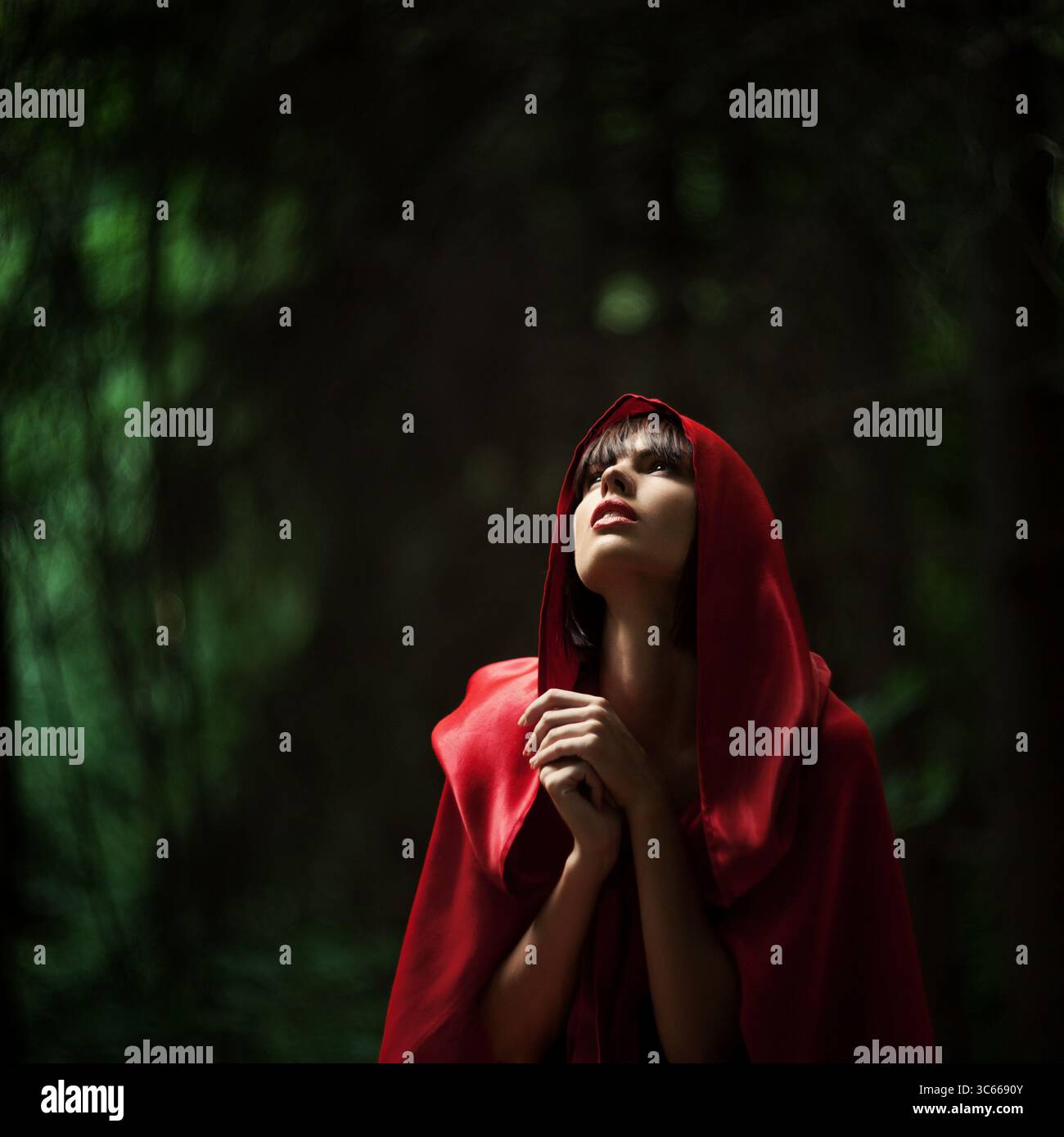 A Mysterious Woman dressed in a captivating Red Cloak stands amidst an ...
