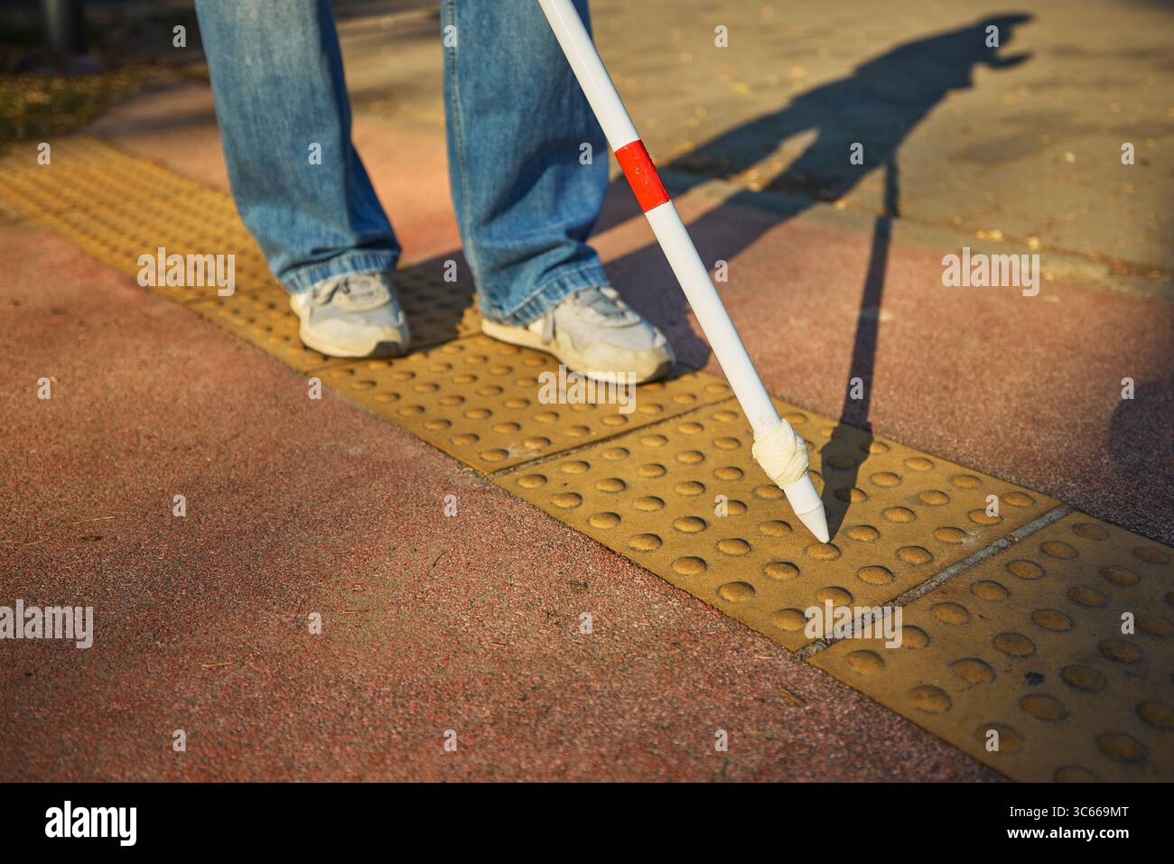 Person walking on tactile paving hi-res stock photography and images ...