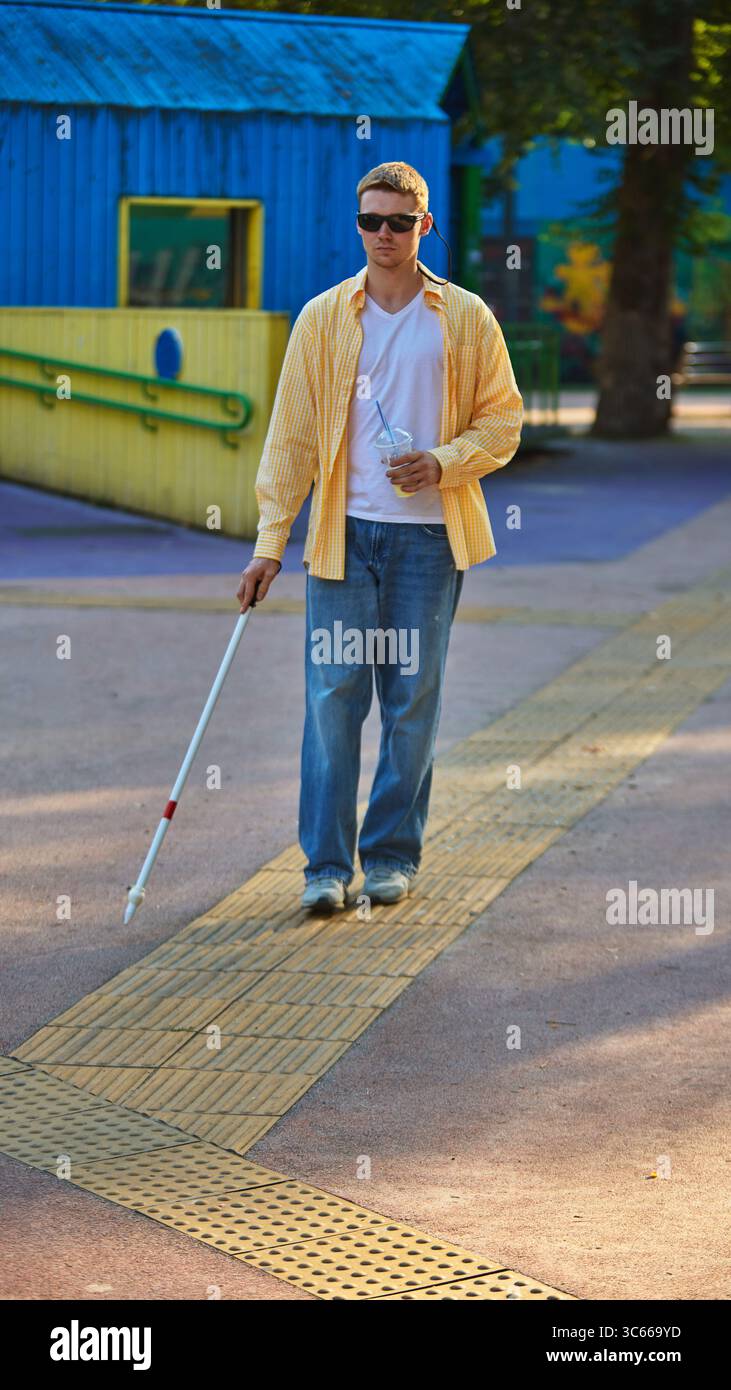 Person walking on tactile paving hi-res stock photography and images ...