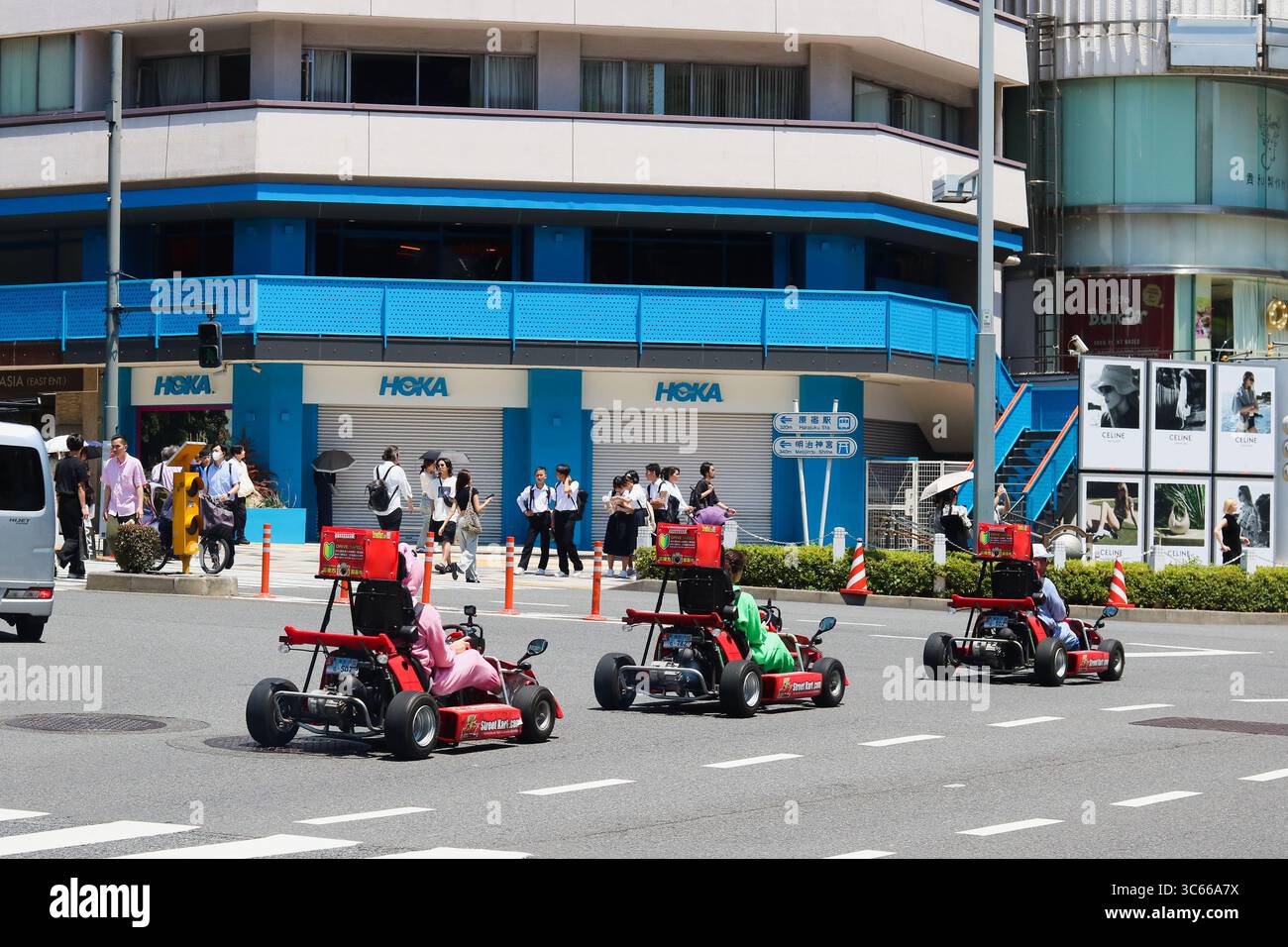 TOKYO, JAPAN - June 18, 2025: People driving rental go-carts over a ...