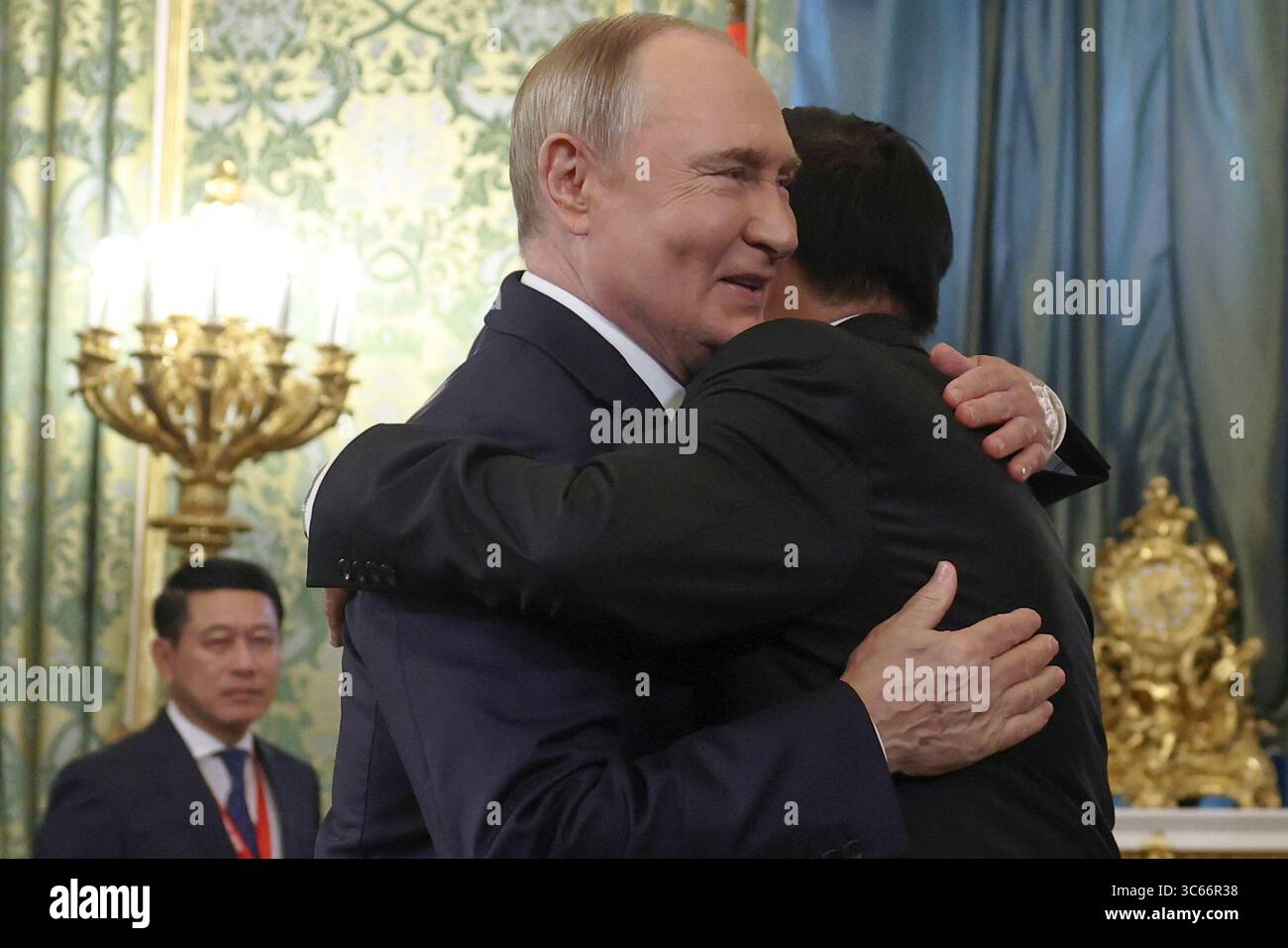 Russian President Vladimir Putin, left, embraces Laotian President ...