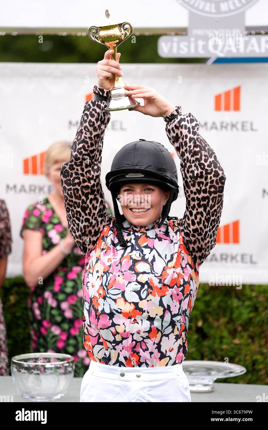 Jockey Sophie Forsyth celebrates with the trophy after winning The ...