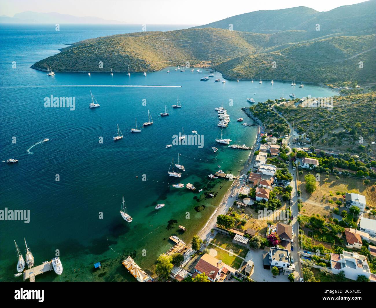 Aerial view of boats scattered across the turquoise bay, nestled ...