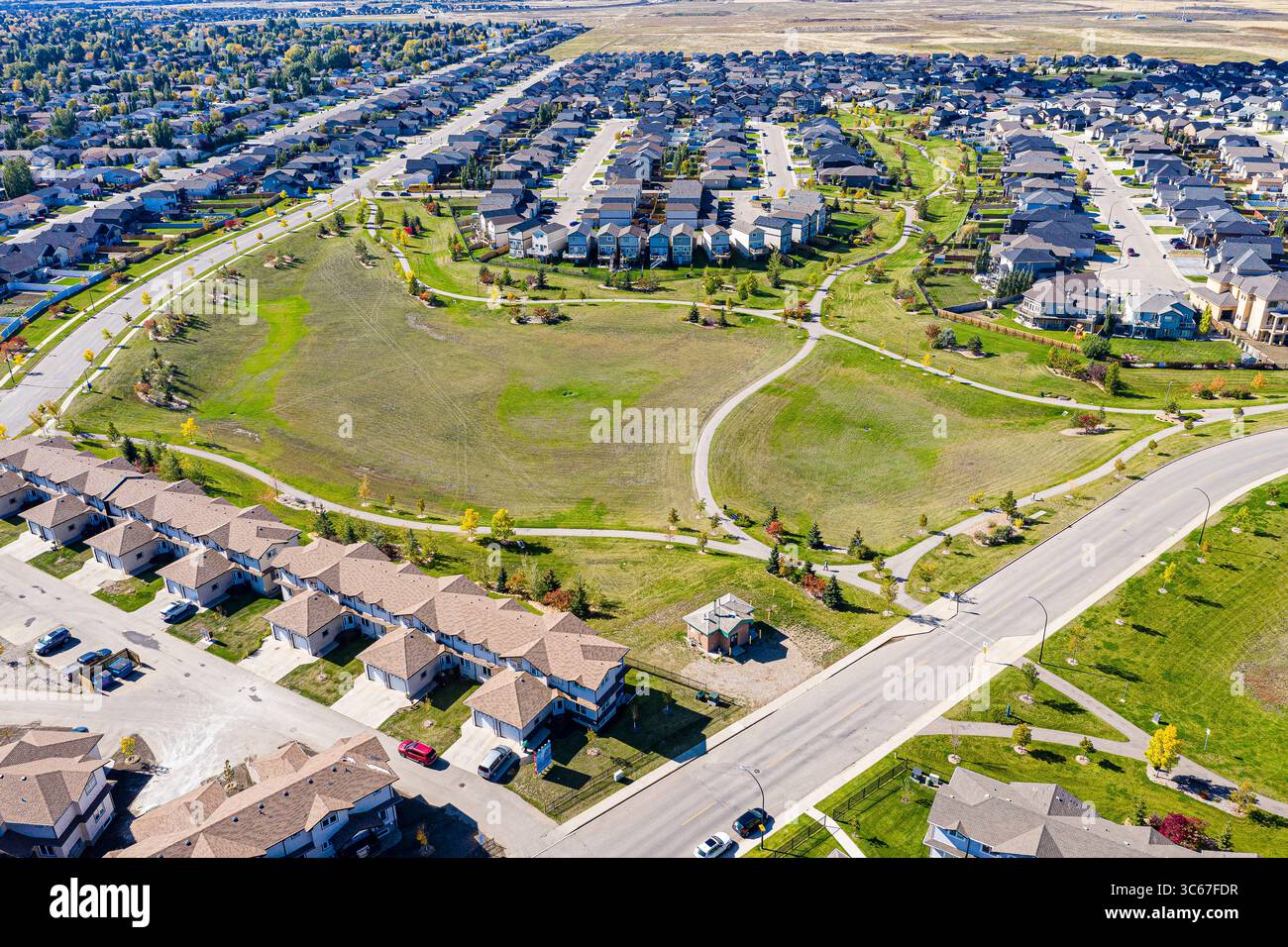 Residential area with houses and a park. The houses are mostly white ...