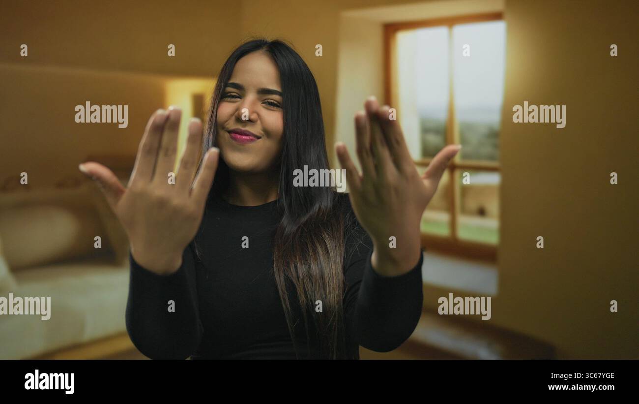 Woman uses hands beckoning in a bedroom background while a young latin ...
