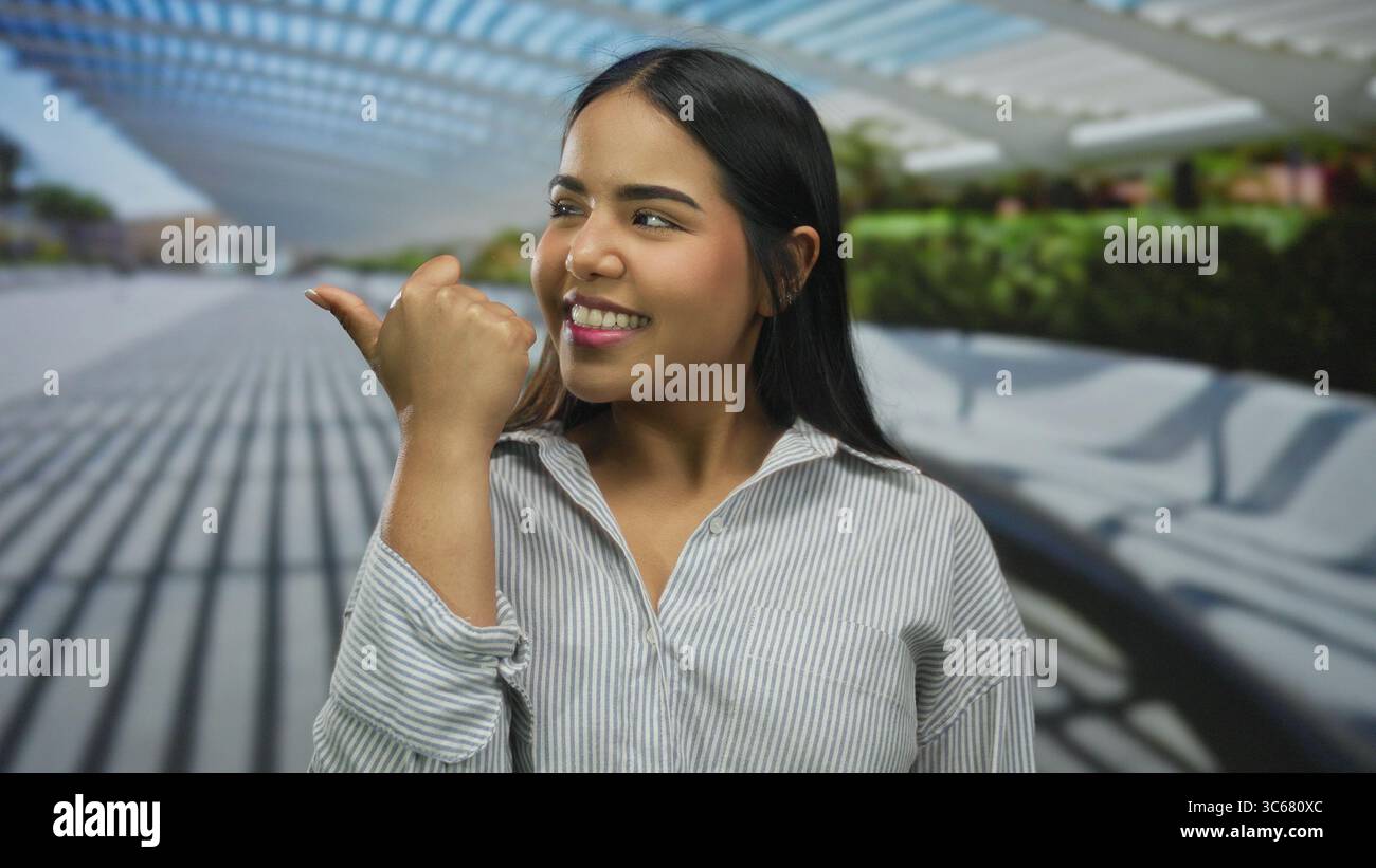 Woman raises thumb pointing along hi-res stock photography and images ...