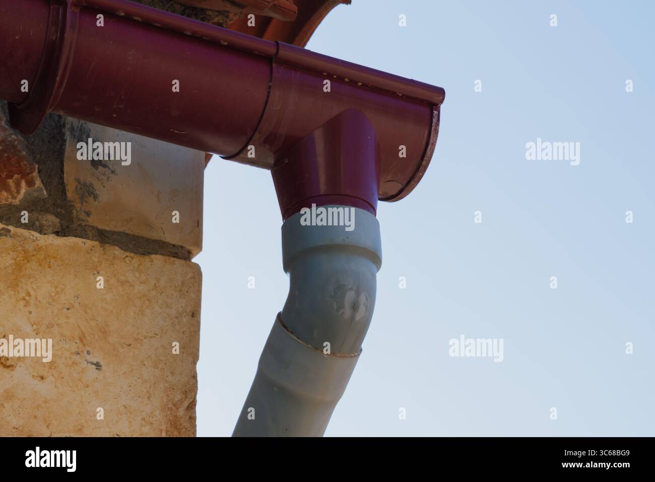 Rainwater drainage system of a building near a stone wall, designed to ...