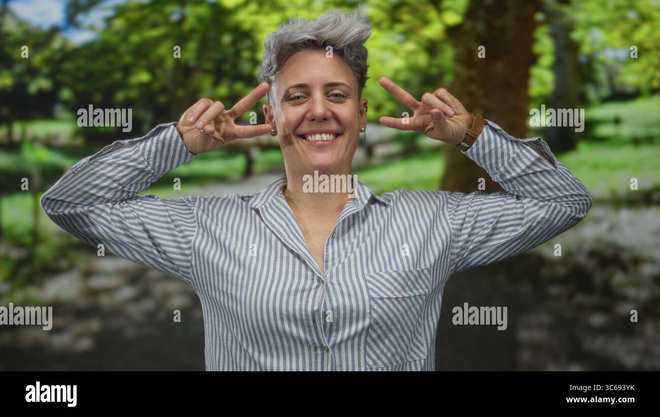 Woman makes double peace sign hi-res stock photography and images - Alamy