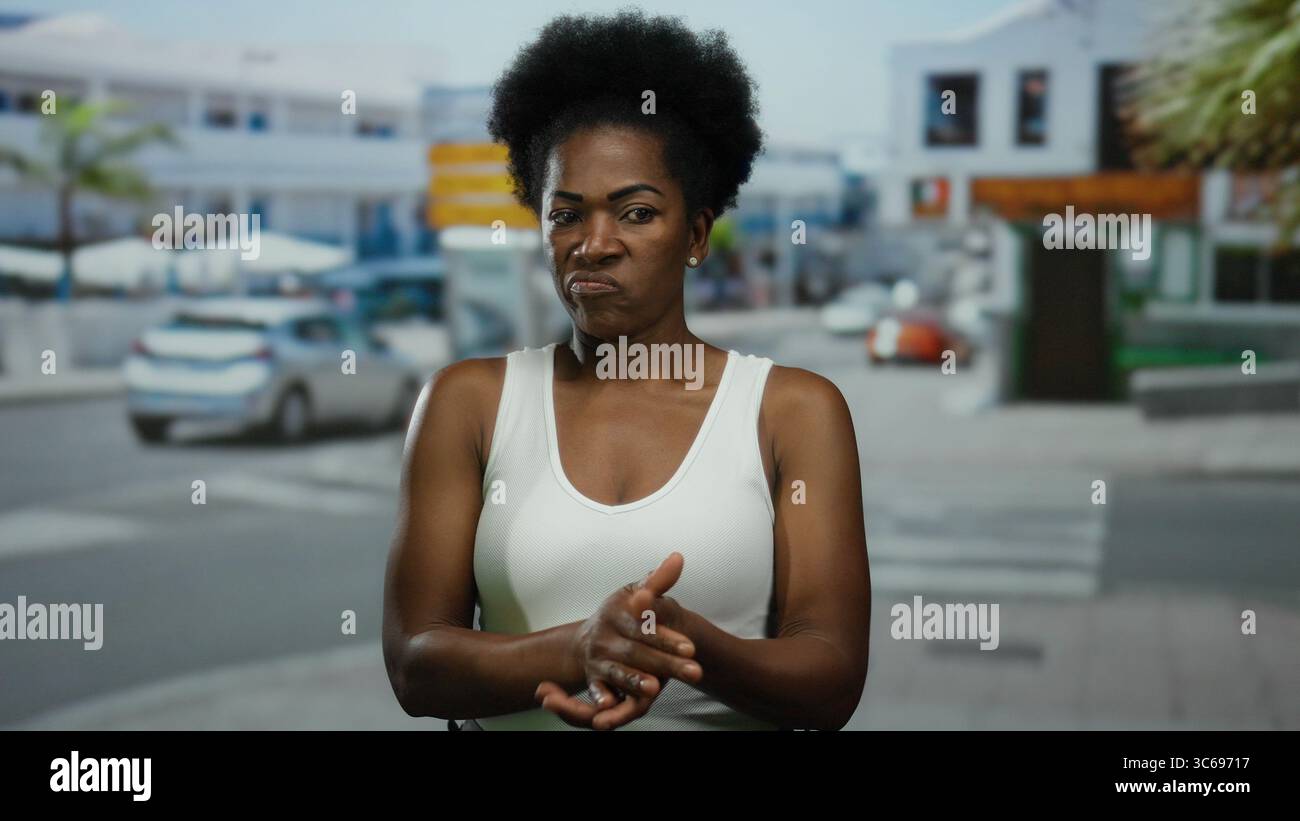 Woman clapping on city street captured outdoors in urban american ...